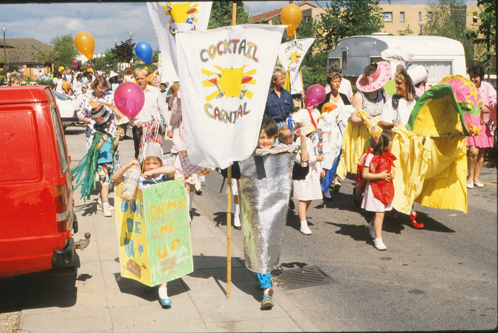 Parade of children and adults in costumes - Living Archive