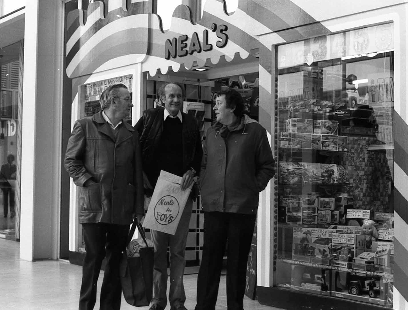 Three people leave Neal's toy shop - Living Archive